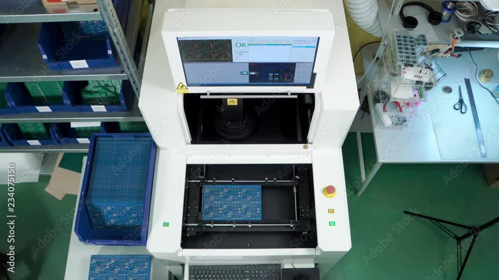 the worker puts the motherboard into the electrical Board inspection ...