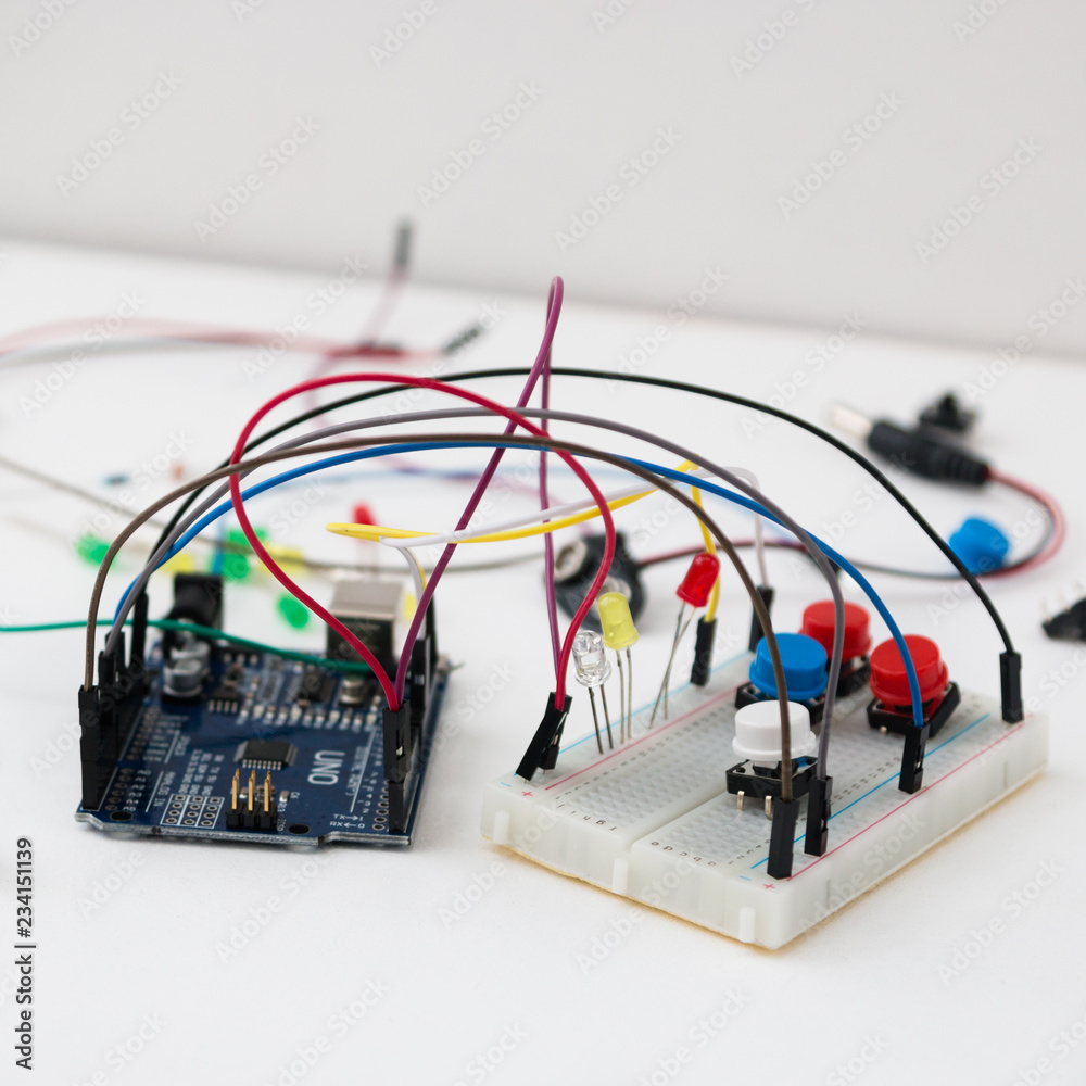 Foto de A cute girl constructs robot arduino and program it. The boards ...