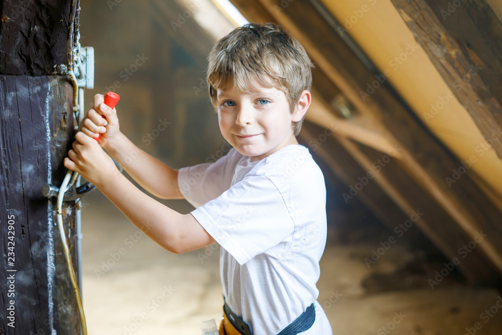 Little kid boy helping with toy tools on construction site. Funny child ...