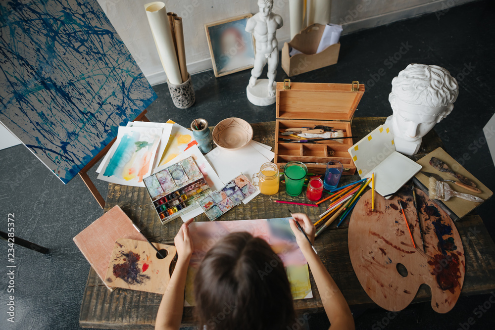 Artist painter young beautiful girl. Working creating process. painting ...