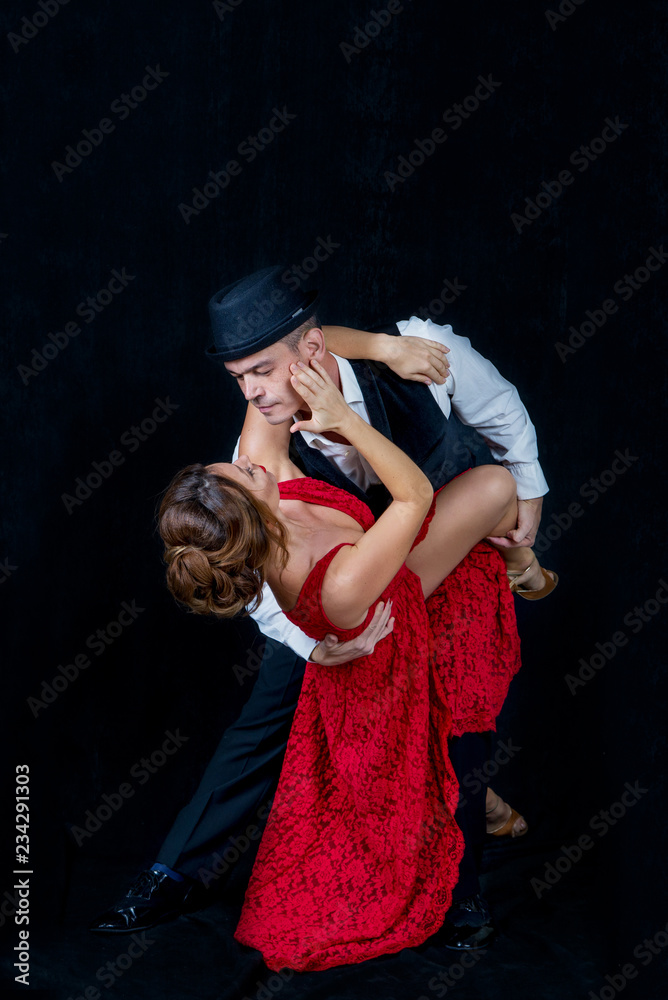 man and woman dancing Latin, ballroom dancing in a pair on a black ...