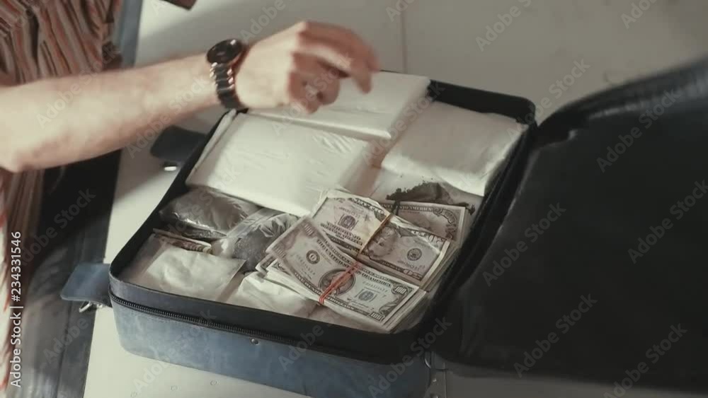 Colombian gangster in a white shirt in the style of the 80s stands near ...