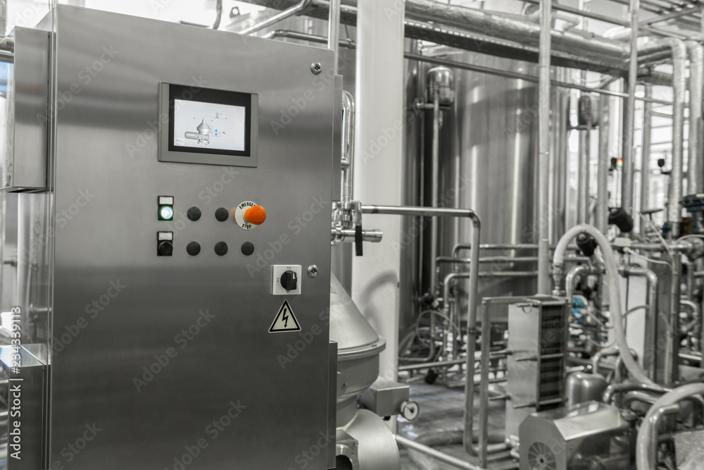 electronic control panel and tank at a milk factory. equipment at the ...
