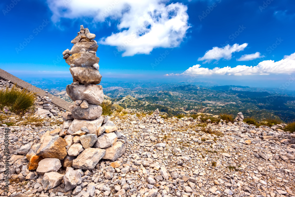 Stone cairns pyramid built on top of a mountain with a panoramic view ...