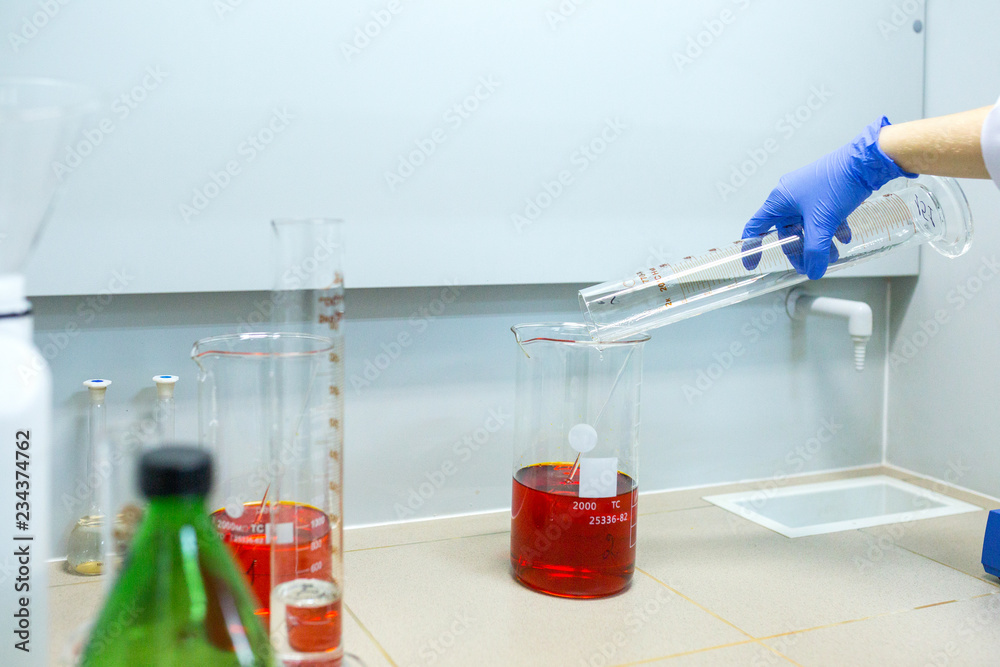 Hands of the scientist in laboratory transfusion chemical substances ...