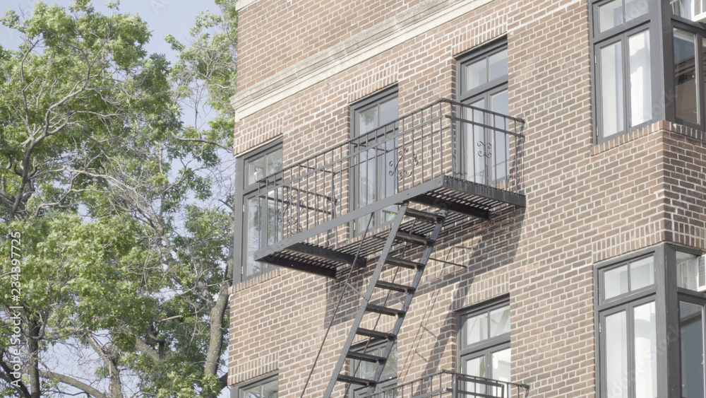 Exterior establishing photo of generic brick facade apartment building ...