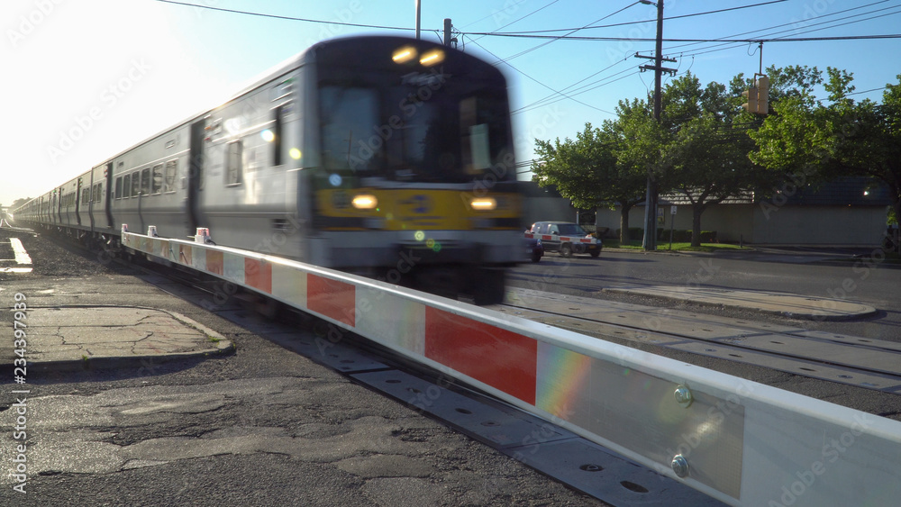 Railroad train crossing safety gate xing at local station. Motion blur ...