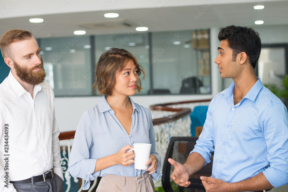 Employees meeting and chatting during lunch break. Three workers ...