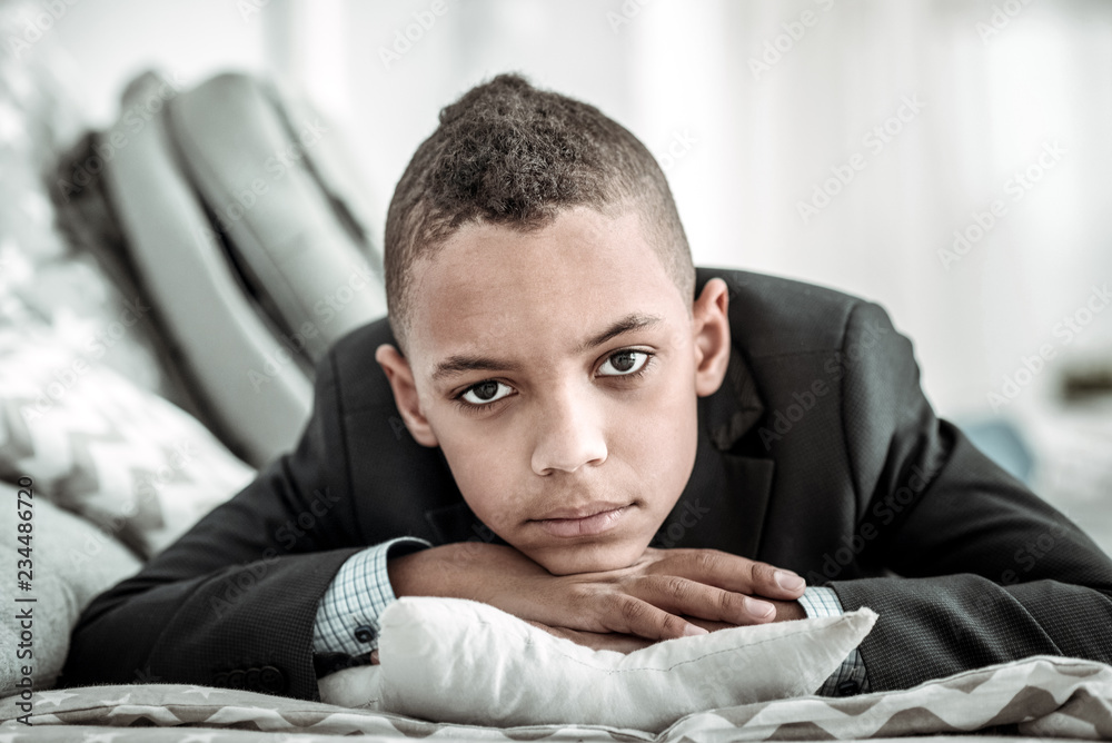 Thoughtful mood. Depressed sad boy looking at you while being in a ...