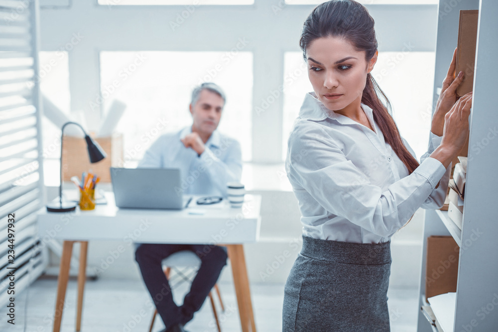 Suspicious work moment. Young woman suspecting her superior in ...