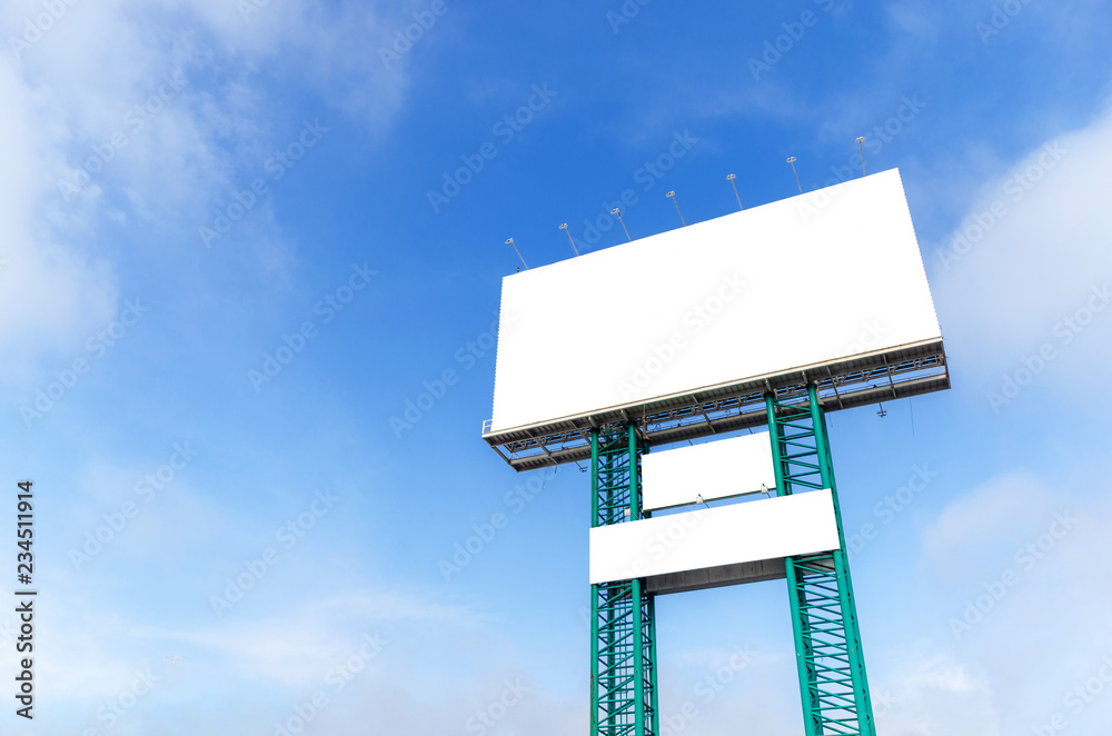 big blank billboard white LED screen outstanding in the blue sky with ...