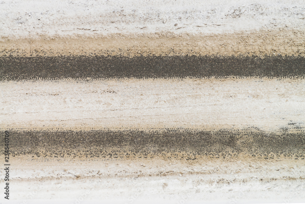 Snowy road close up. Car track in dirty snow. Track of tyres. View from ...