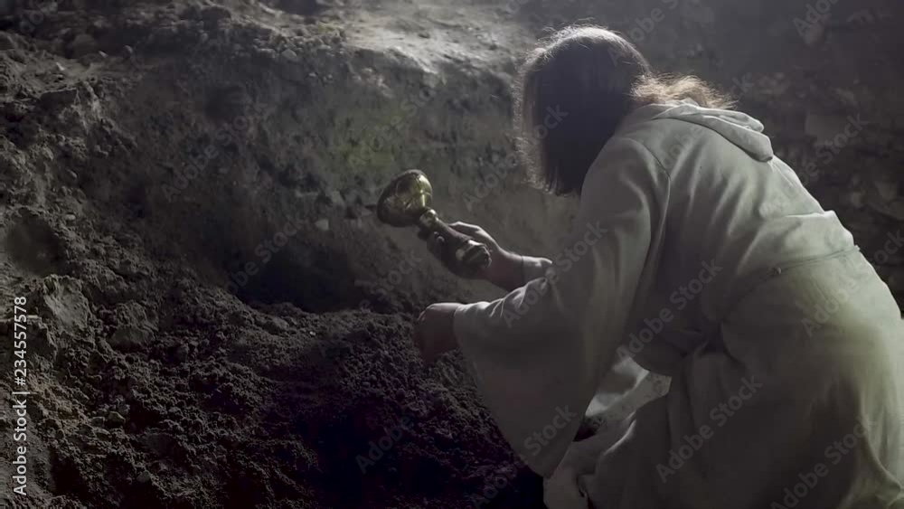 A man like Jesus Christ is digging a hole in the dungeon, a man is ...