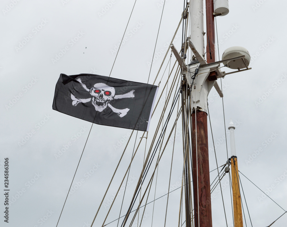 Jolly Roger / Pirate flag Skull and crossbones flying from the mast of ...