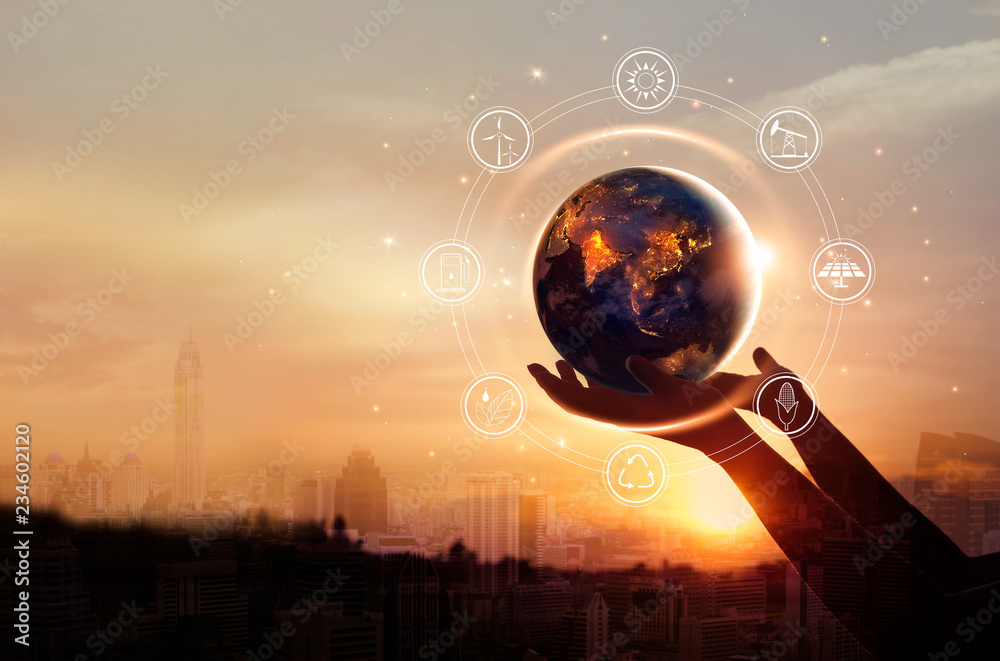 Earth at night was holding in human hands with energy resources icon on ...