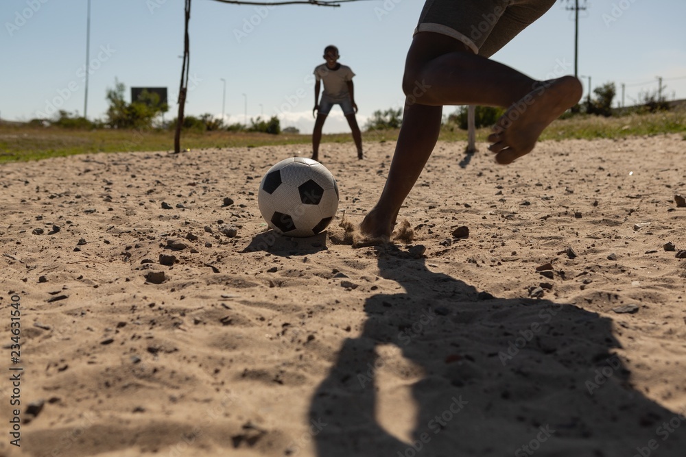 Kids playing football in the ground Stock Photo | Adobe Stock