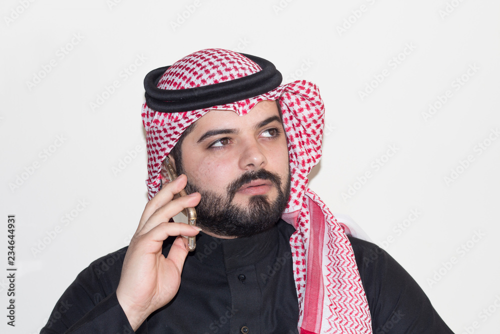 Arabian man (Gulf area) profile, wears traditional clothes. uses mobile ...