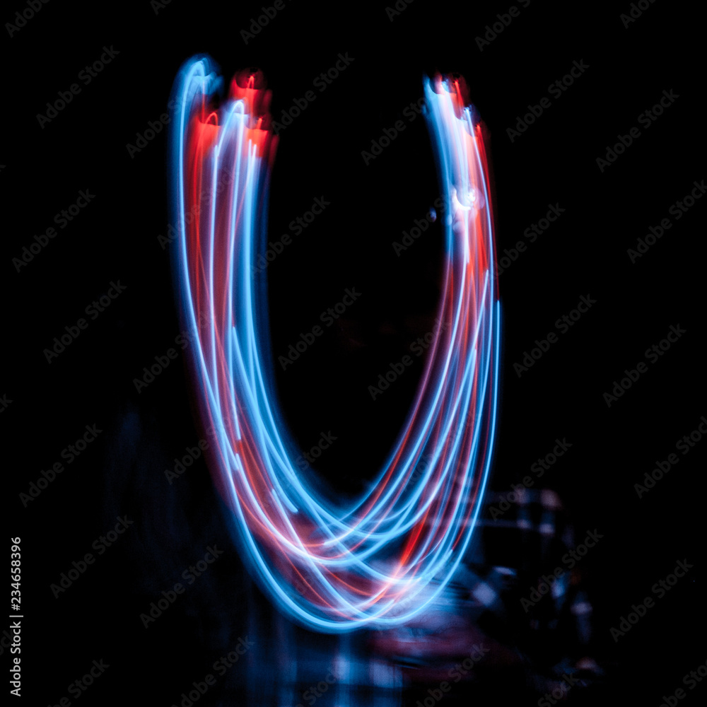 Letter U of the alphabet made from neon sign. The blue light image ...