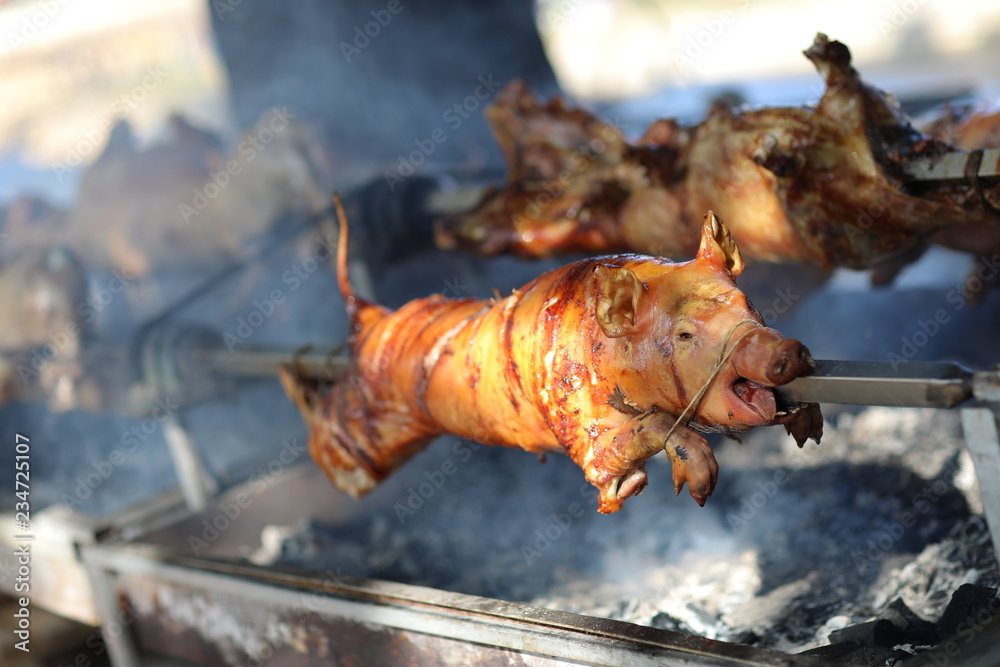roasted pig on the stick Stock Photo | Adobe Stock