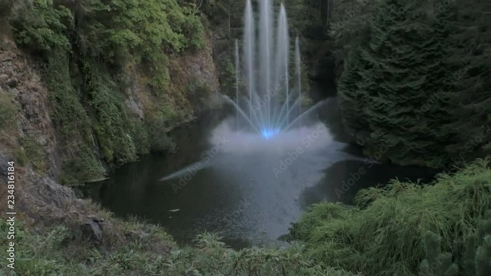 A pan tilt shot reveals multiple streams spouting from a lake as a ...