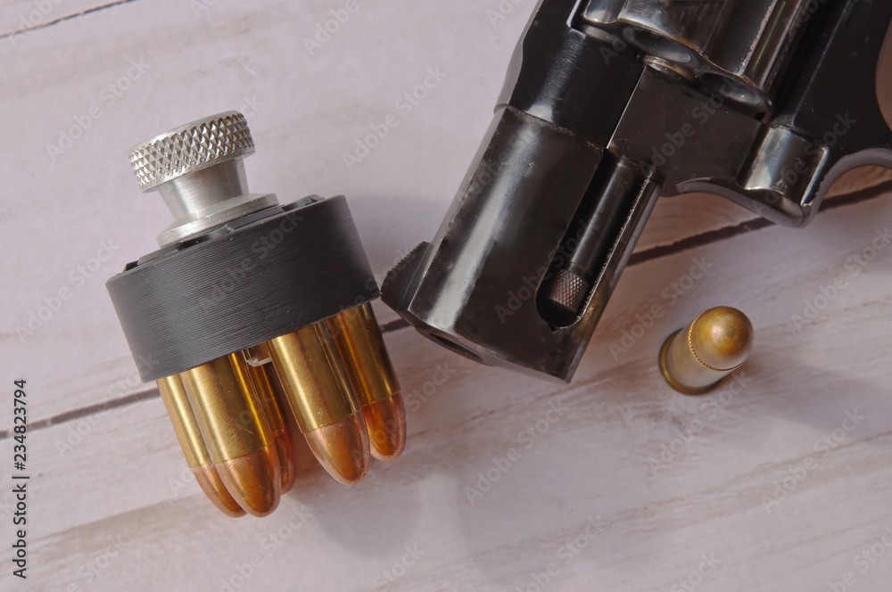 A loaded speed loader loaded with 38 special full metal jacket bullets ...