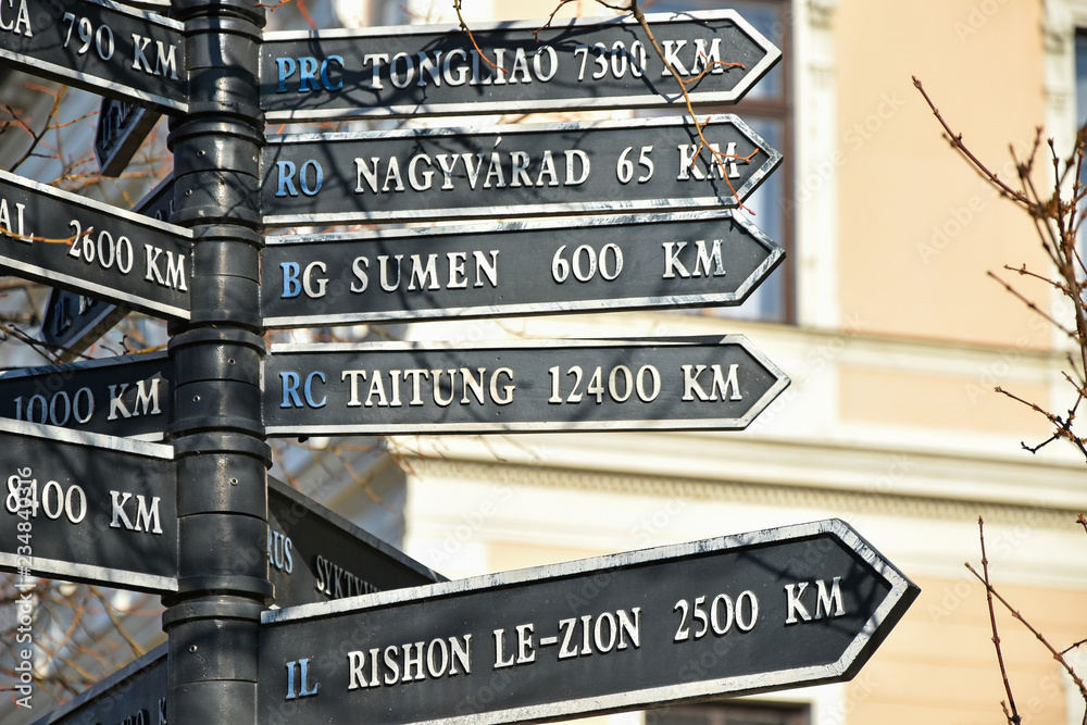 Foto de Road signs with distances and city names do Stock | Adobe Stock