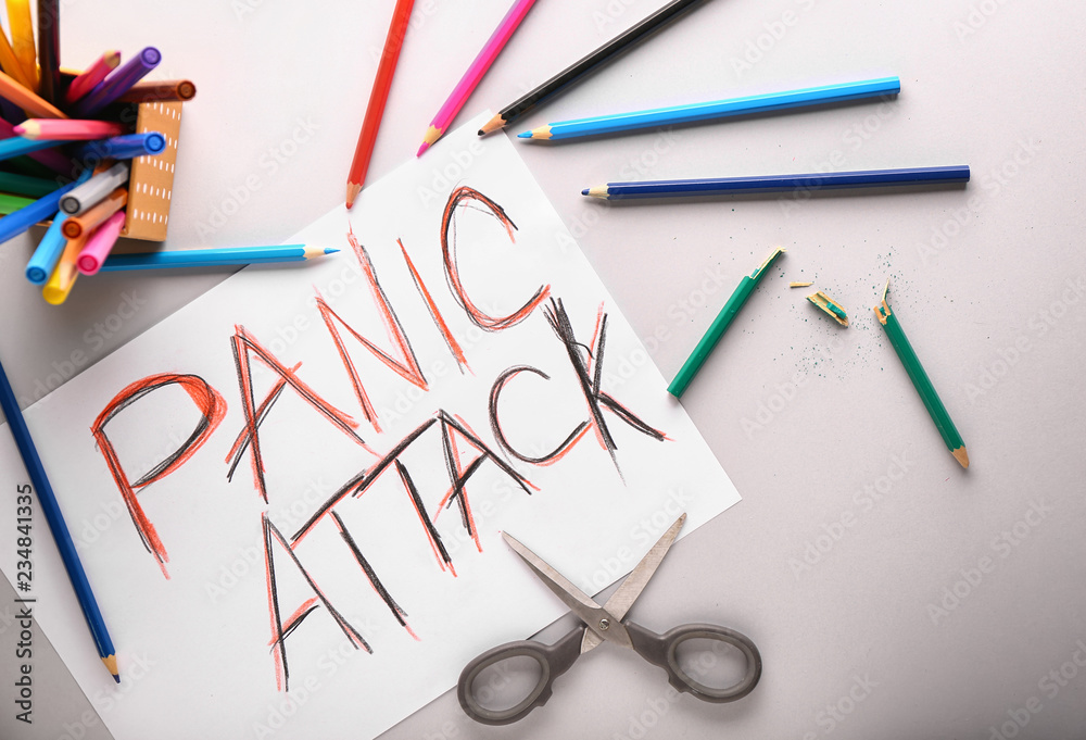 Paper with text PANIC ATTACK and colorful pencils on white background ...