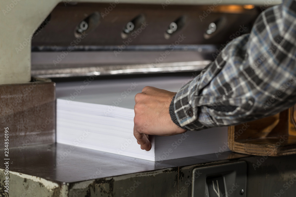 Front view of a paper guillotine in commercial printing industry ...