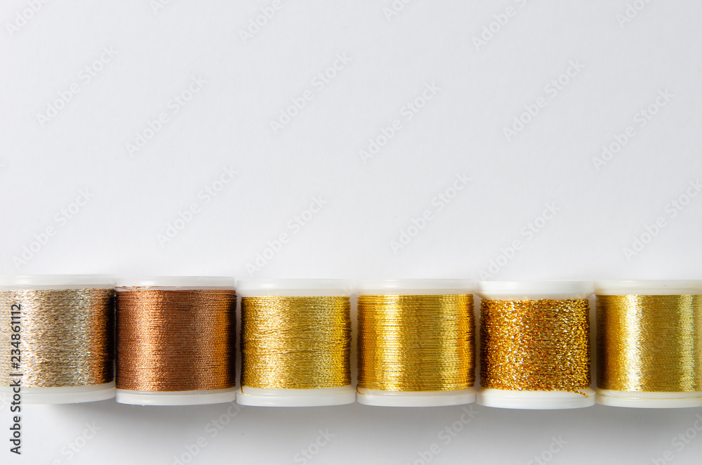 Golden thread coils on white background, sewing, place for text. Top ...