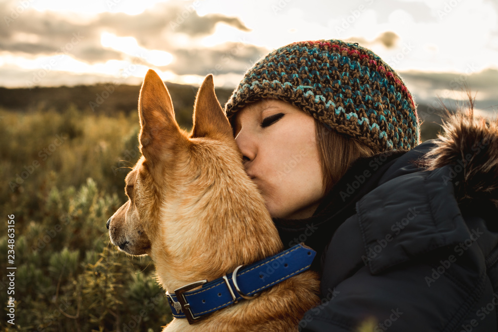 Young woman happy, kissing and hugging her dog. Concept of love between ...