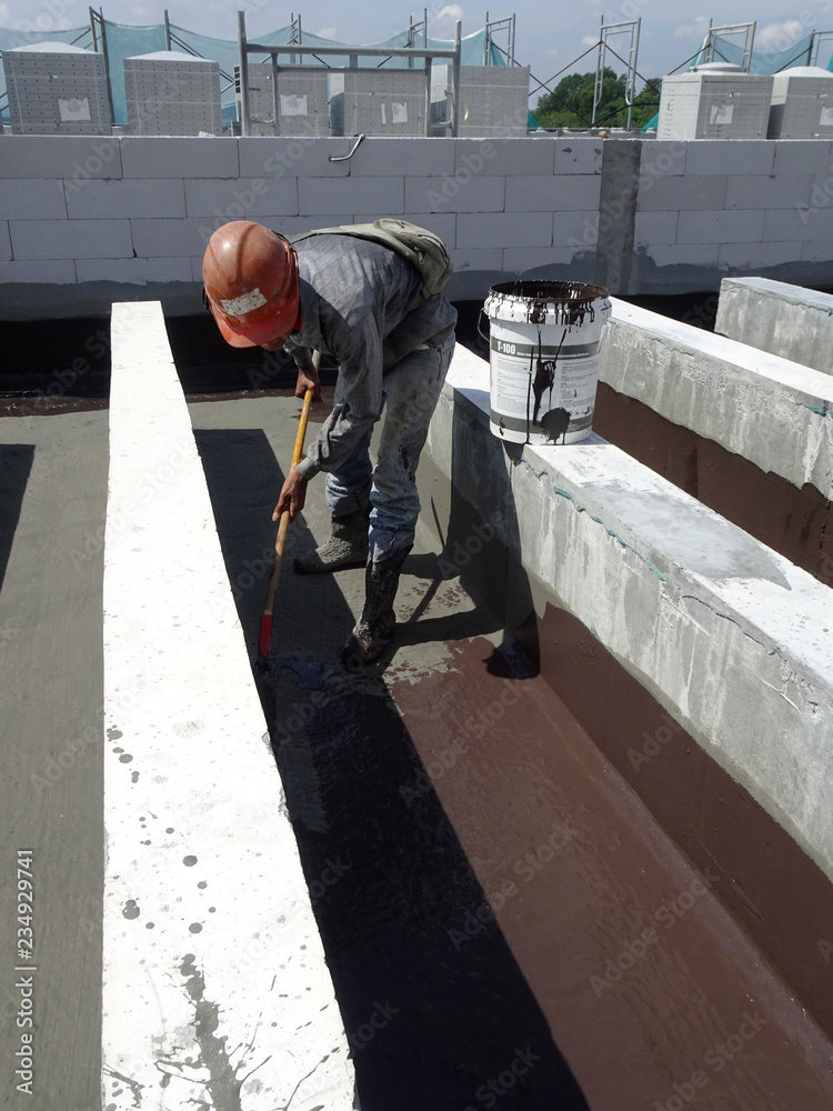 Waterproofing membrane applied by construction workers on top of ...