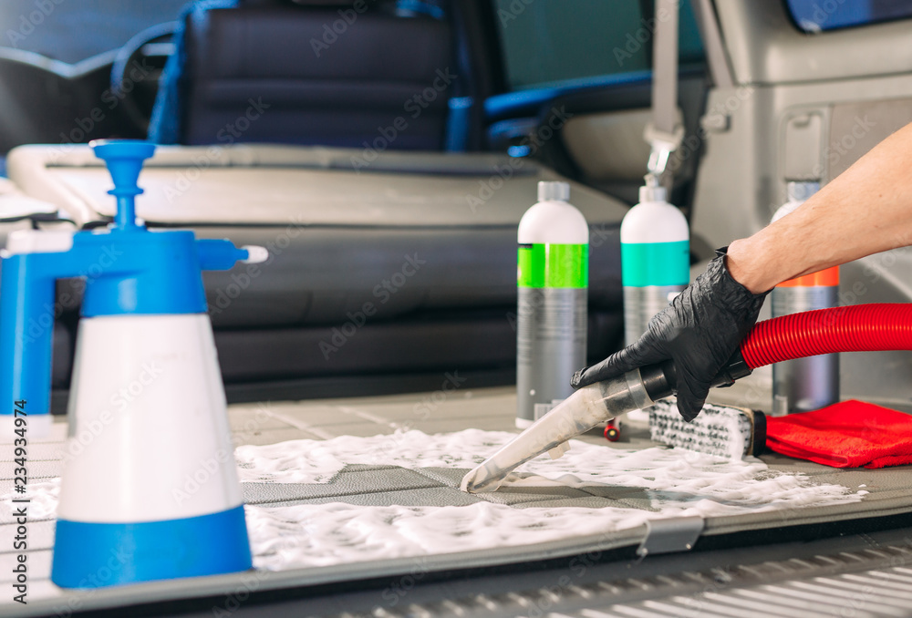 Car chemist. Chemical treatment of the car trunk. Stock Photo | Adobe Stock