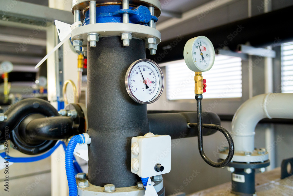 The equipment of the boiler-house, valves, tubes, pressure gauges ...