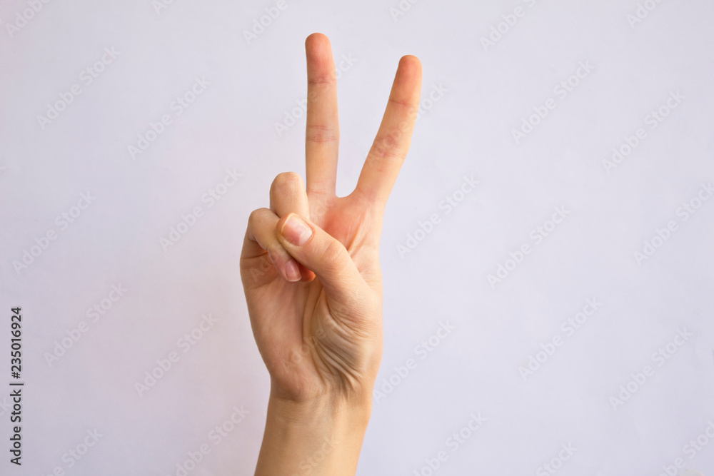 Hand with two fingers up in the peace or victory symbol. Also the sign ...