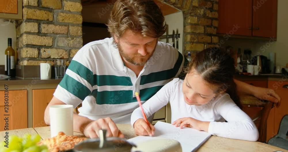 Father helping daughter in studies in kitchen 4k Stock Video | Adobe Stock