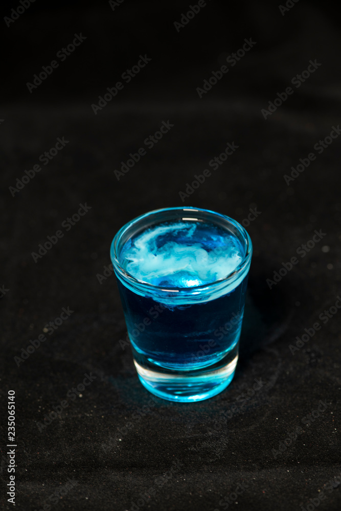 Jellyfish shot cocktail with blue curacao, sambuca, vodka and milk ...