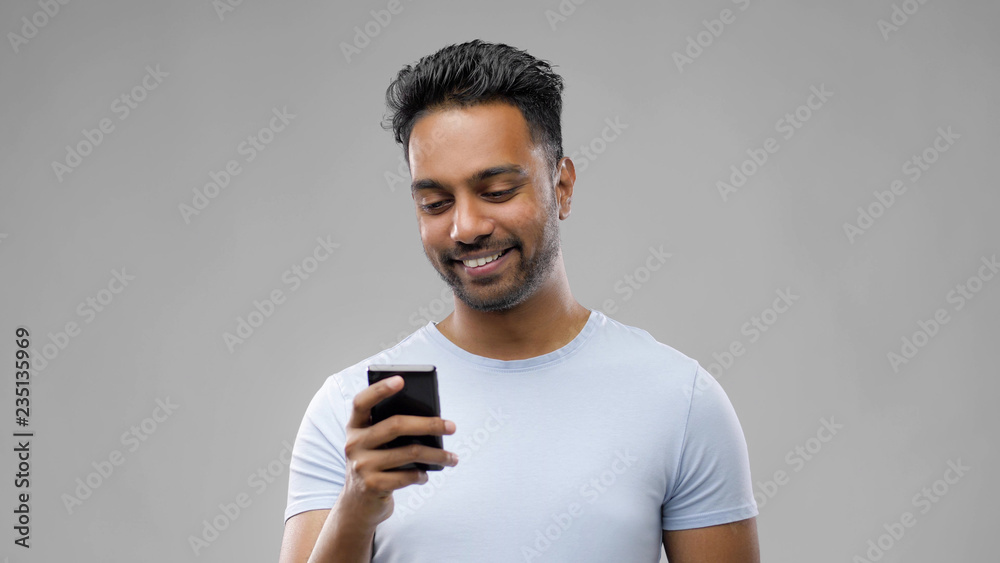 technology, internet, communication and people concept - happy indian ...