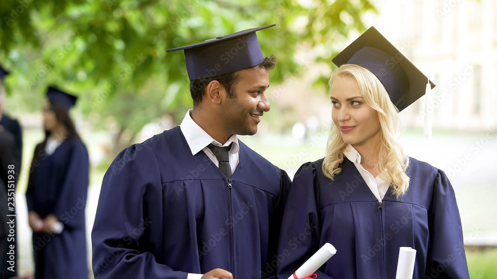 Graduate students confidently watching to each other, best friends ...