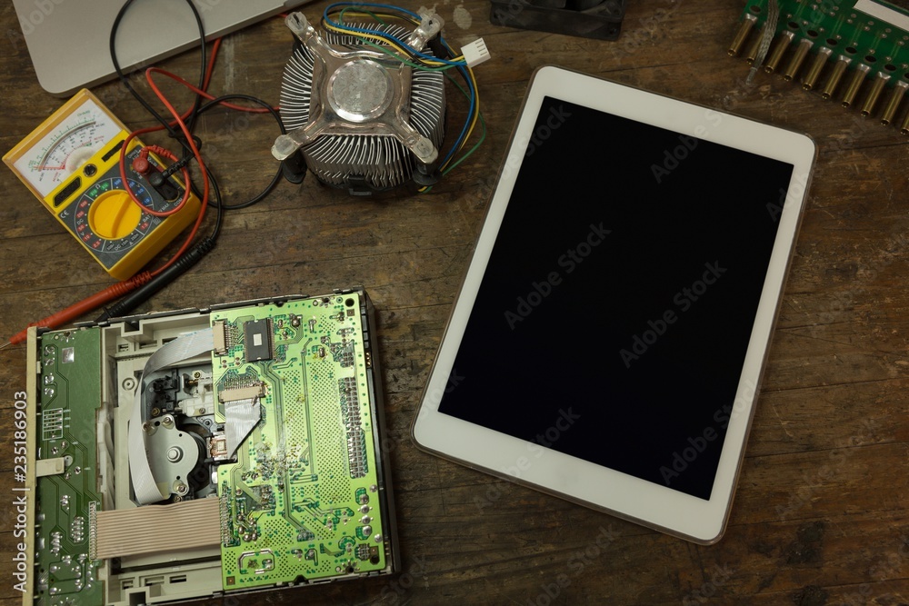Digital tablet and circuit board on table Stock Photo | Adobe Stock