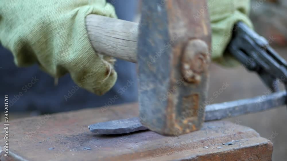 blacksmith works metal. Craftsman, the Highlander on private smithy in ...