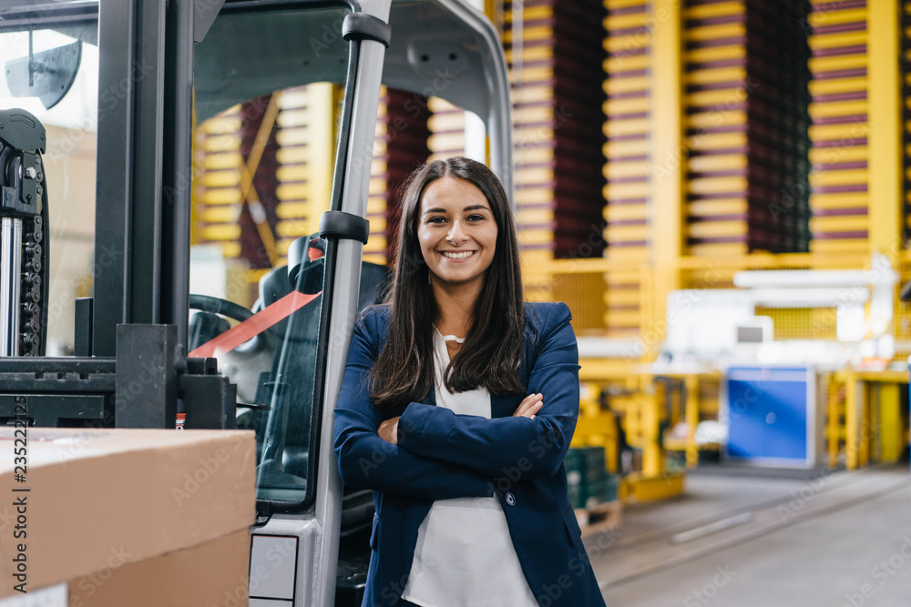 Confident woman standing in logistics center, with arms crossed Stock ...
