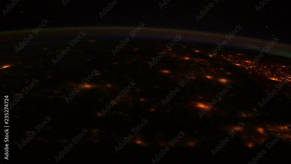 Glowing cities on the night side of Earth as seen from space. Stills ...