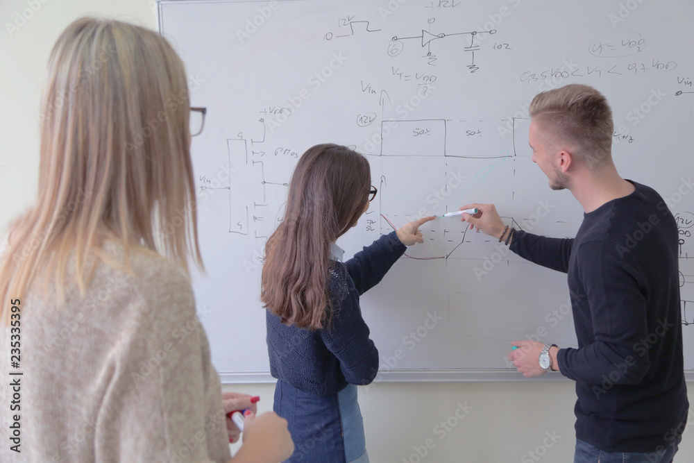 Two young college male and female students with young female teacher ...