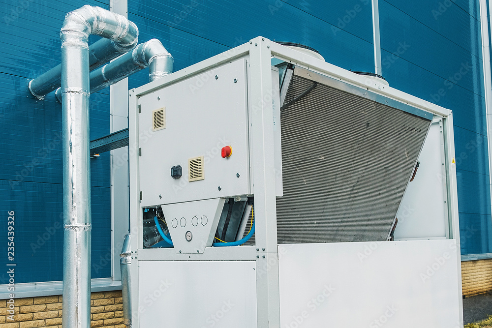 Industrial cooling unit for central ventilation system standing outside ...