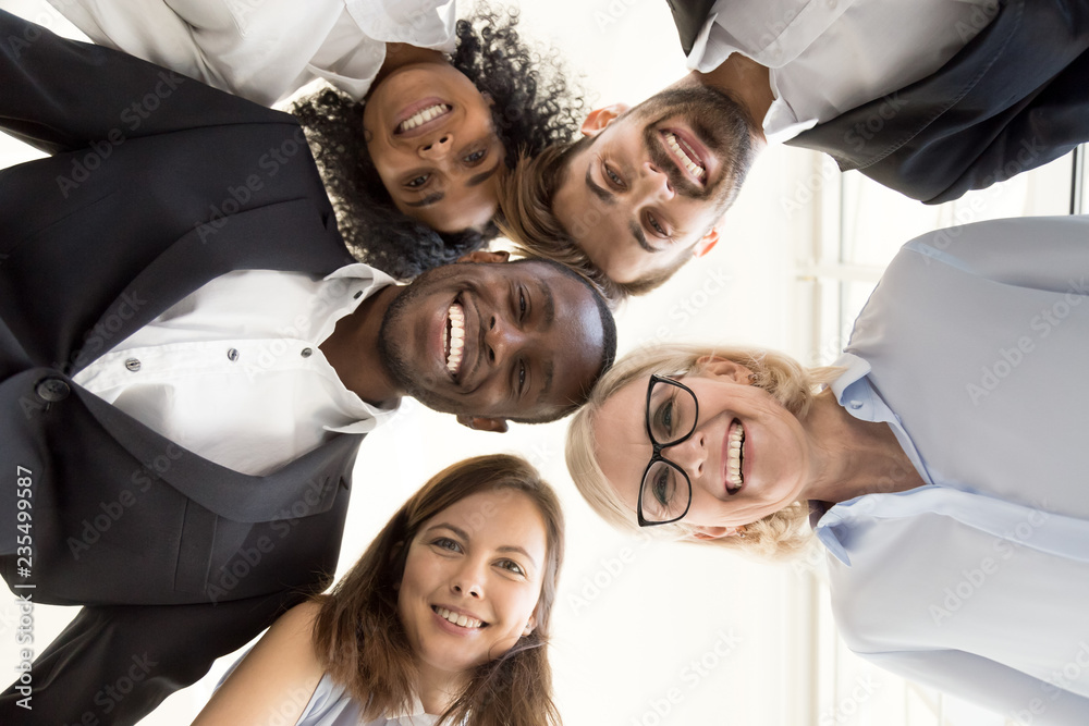 Happy diverse business people team gathering in circle looking at ...
