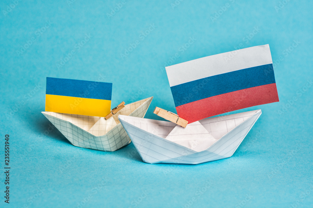 paper ships with flags of Ukraine and Russia, symbol of conflict at sea ...