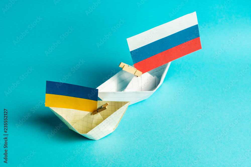 paper ships with flags of Ukraine and Russia, symbol of conflict at sea ...