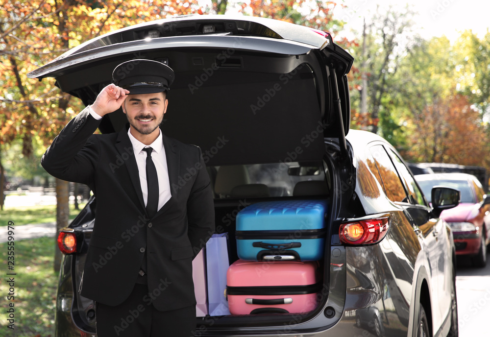 Young driver standing near car with open trunk outdoors Stock Photo ...