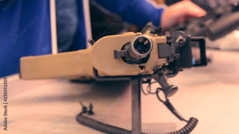 Weapon optics sight of sniper rifle with man close-up in store or shop ...