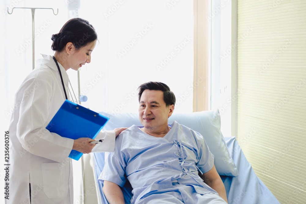 Doctor women standing talking old patient men on bed with Medical in ...